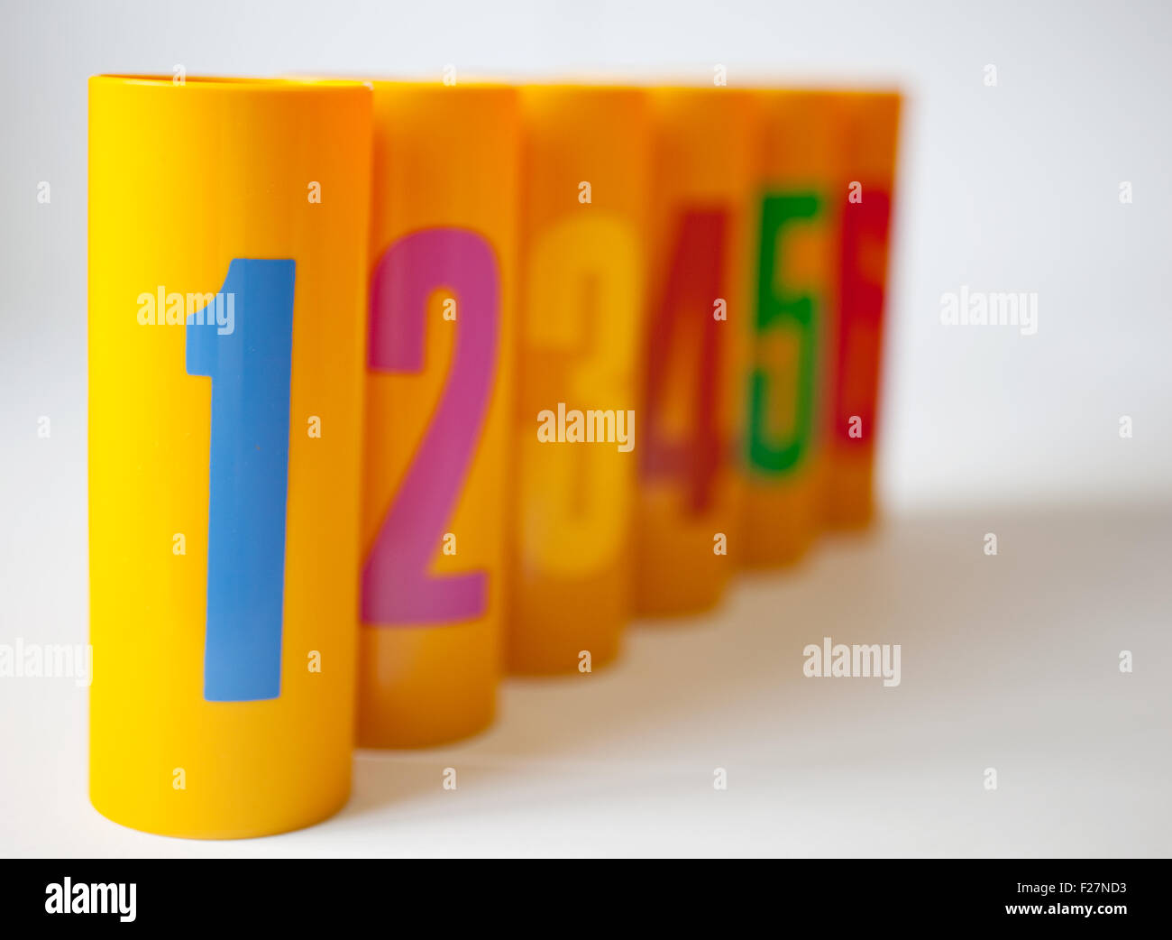 Yellow plastic cans numbered one to six - colored numbers Stock Photo ...
