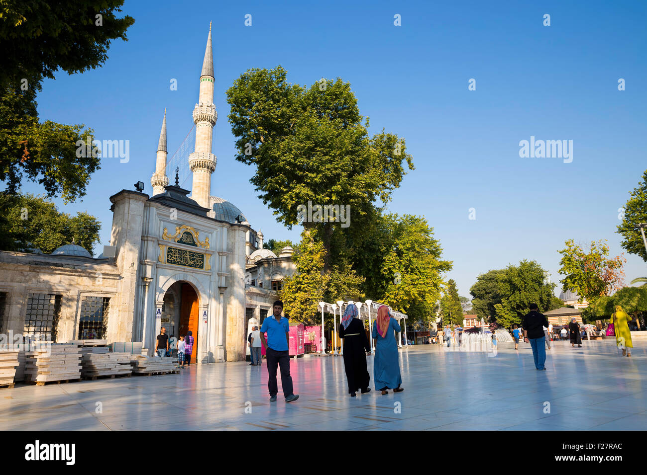 Tourists and Turkish people walking near The Eyup Sultan Mosque, square ...