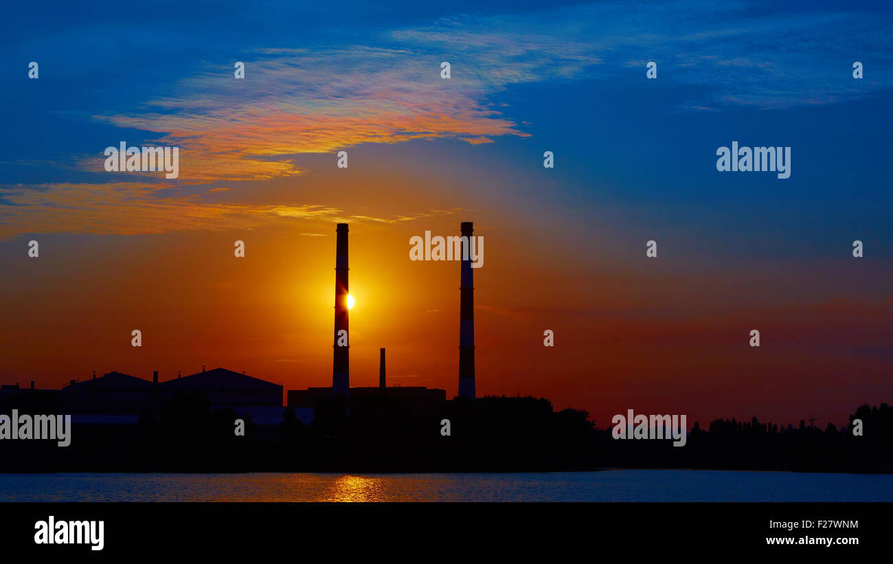 factory in silhouette and sunrise sky Stock Photo - Alamy