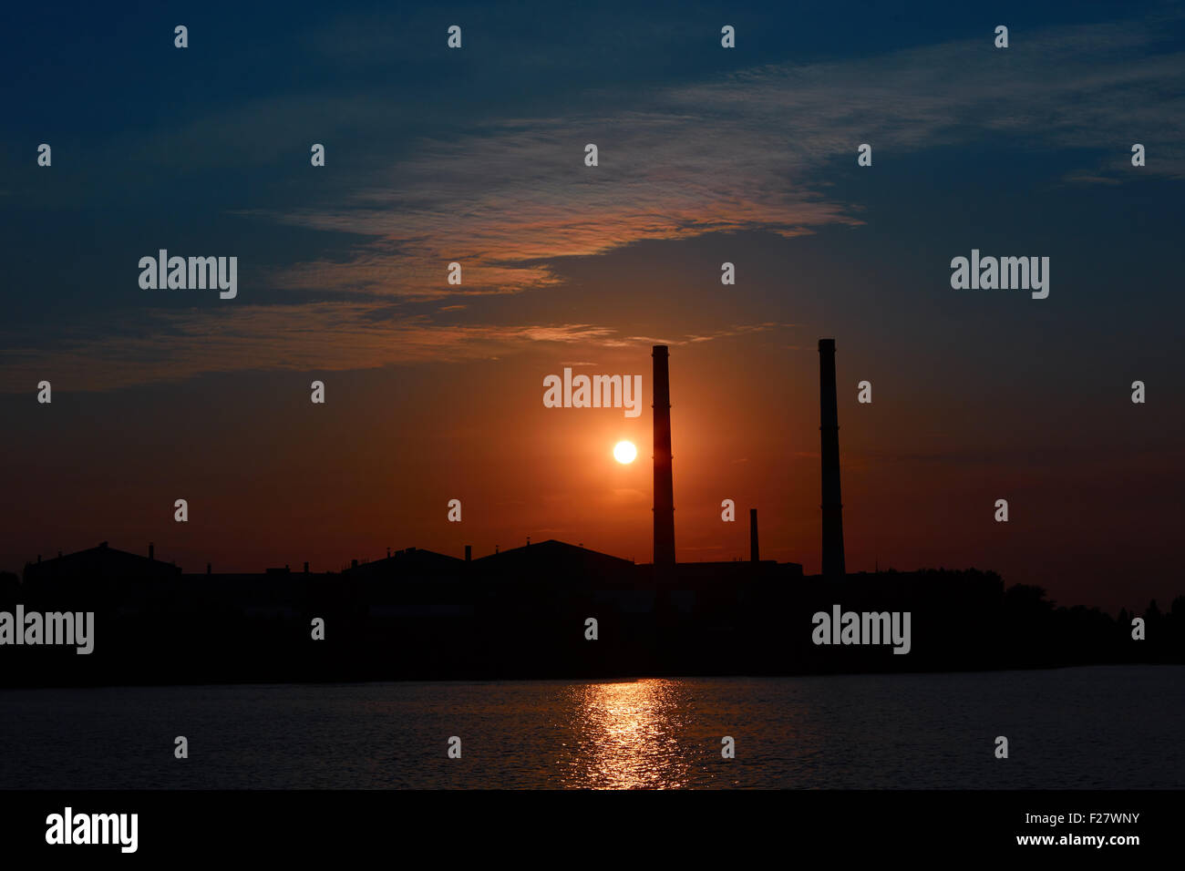 factory in silhouette and sunrise sky Stock Photo - Alamy