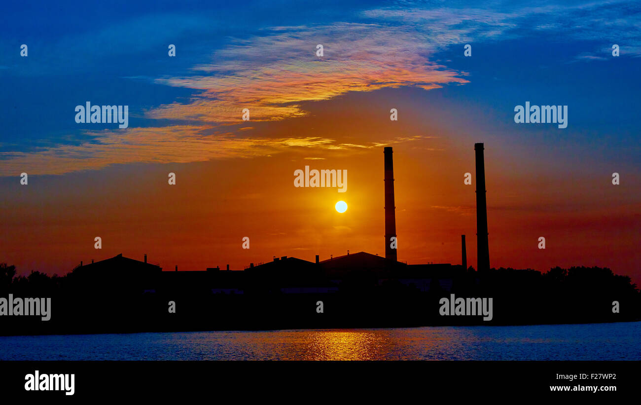 factory in silhouette and sunrise sky Stock Photo - Alamy