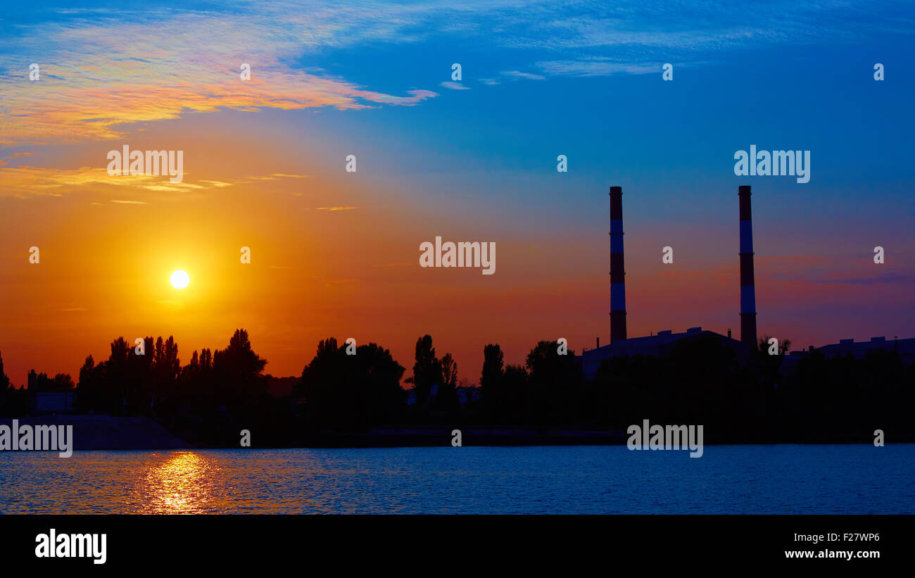 factory in silhouette and sunrise sky Stock Photo - Alamy