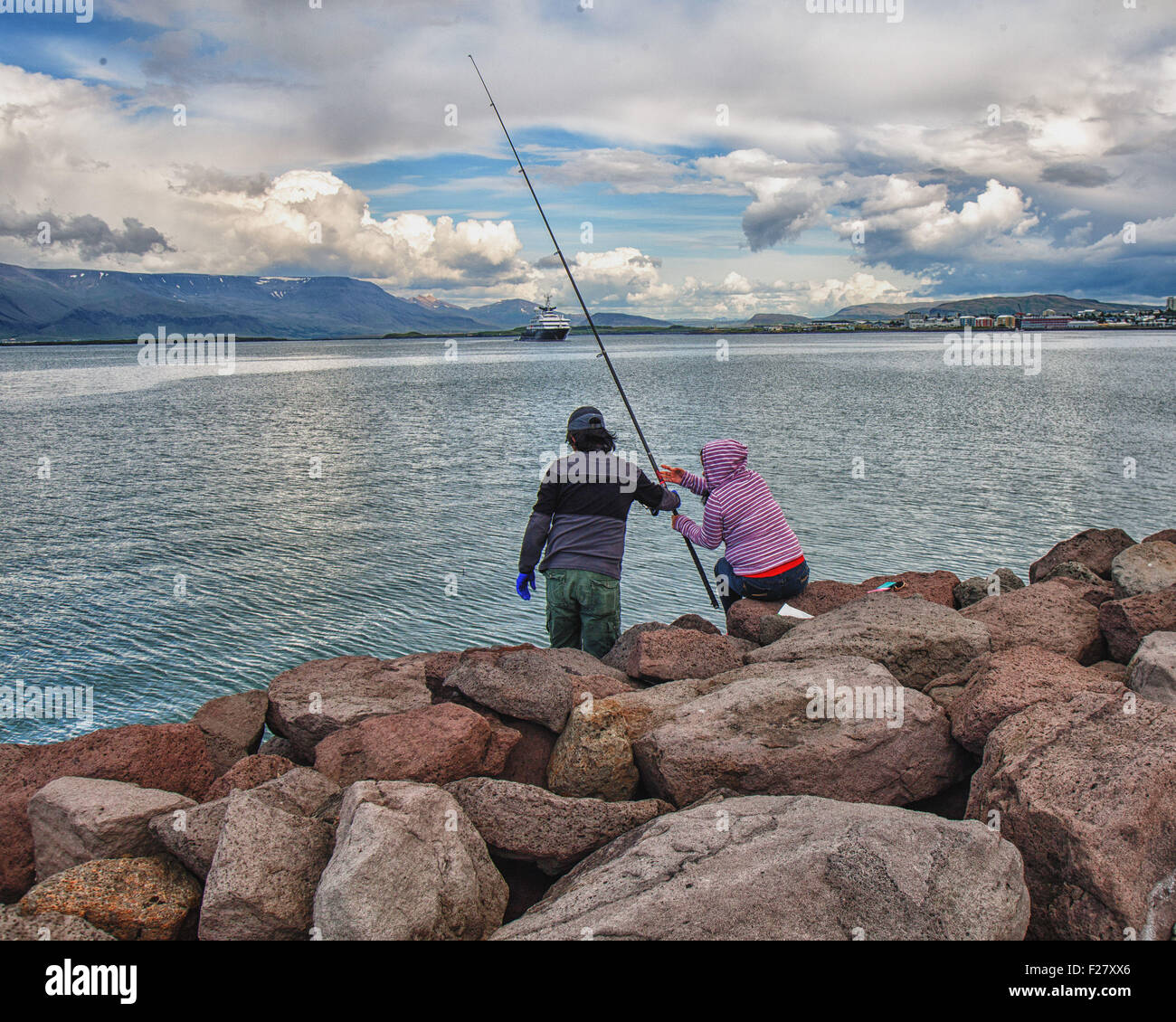 Reykjavik, Iceland. 28th July, 2015. A couple fish in Faxa Bay ...