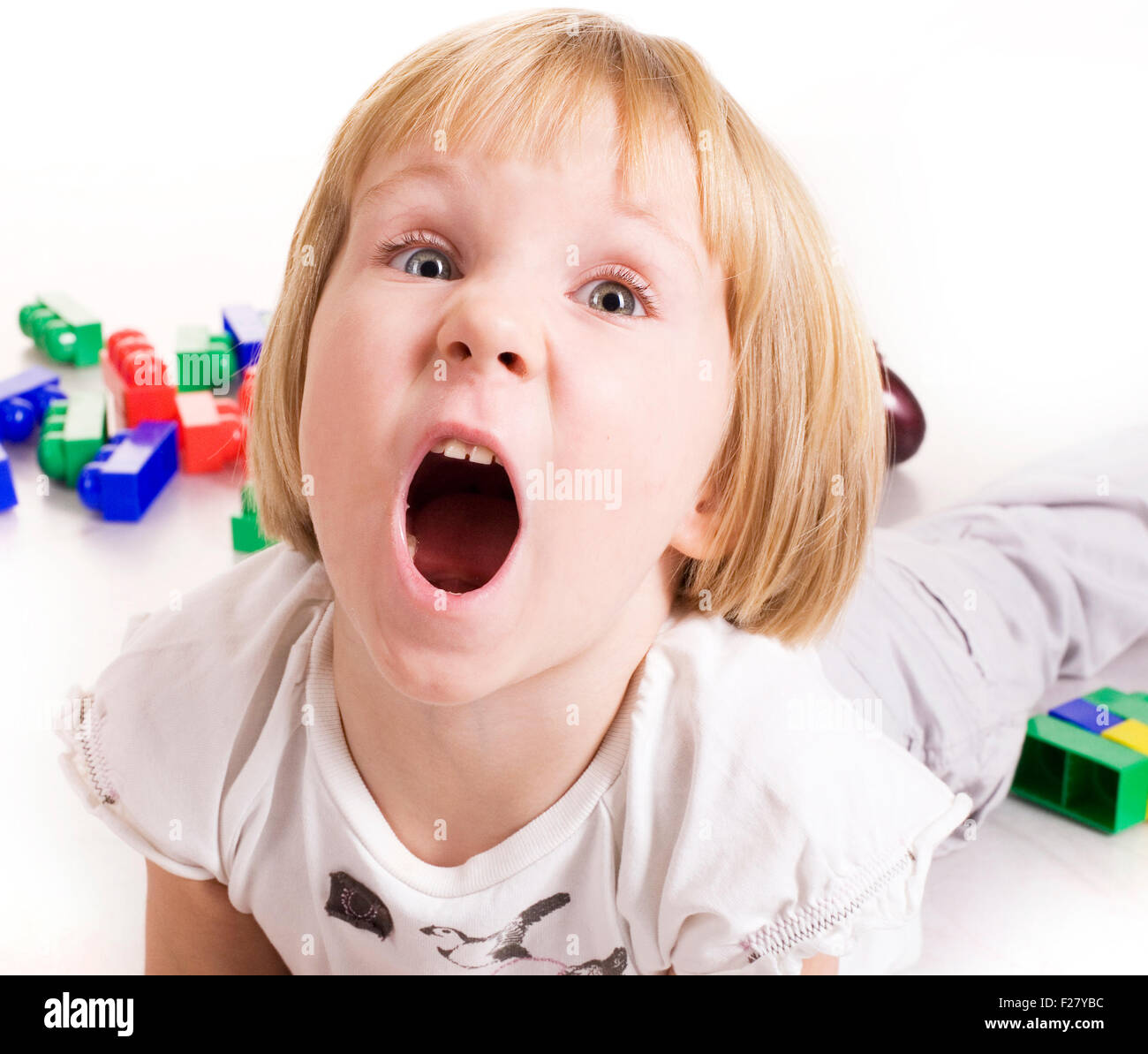 little cute blond girl emotional screaming in camera on white ...
