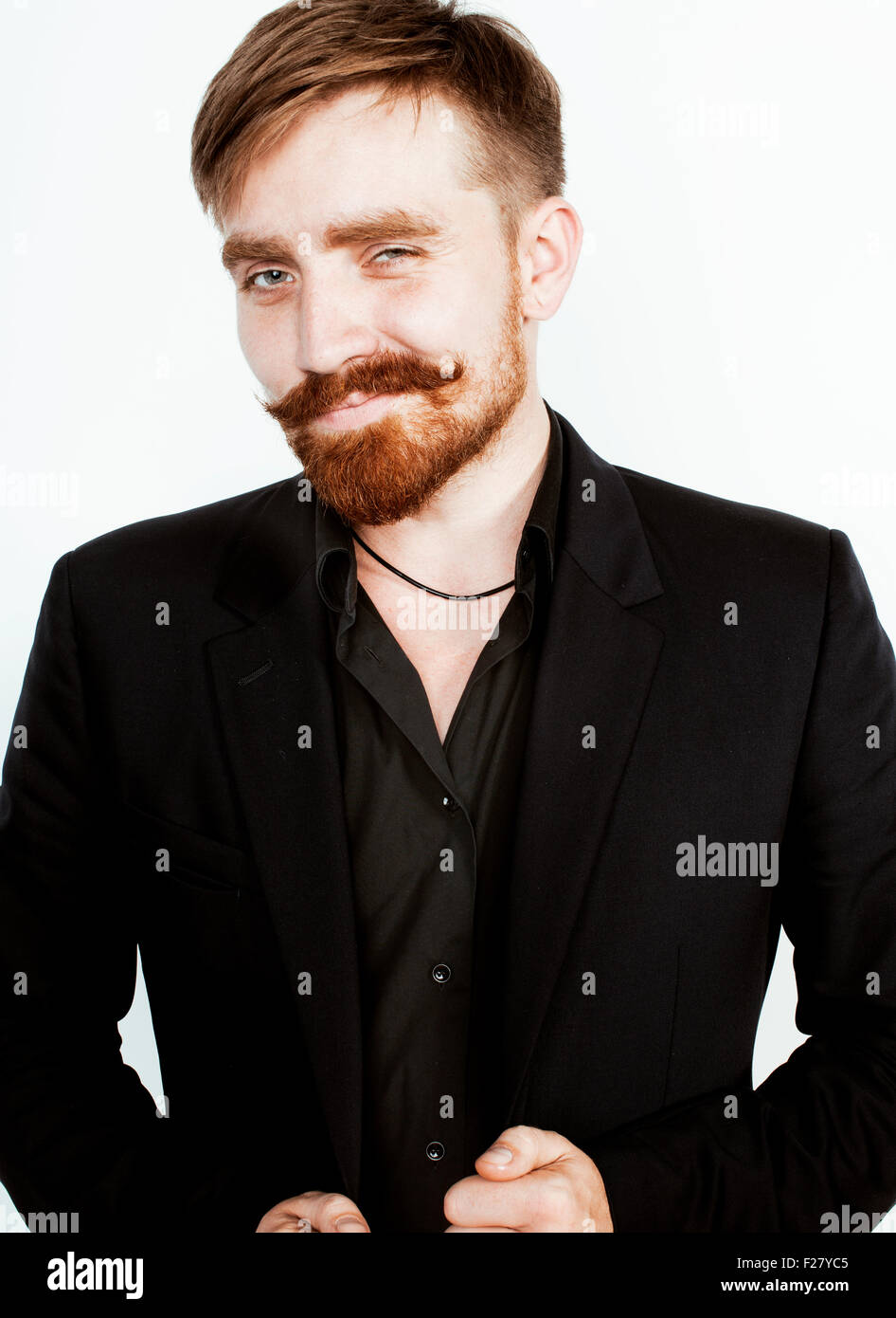 young red hair man with beard and mustache in black suit on white ...