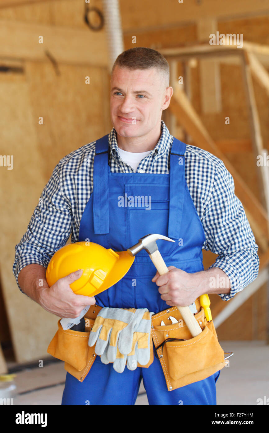 portrait of workman with hammer and helmet Stock Photo - Alamy