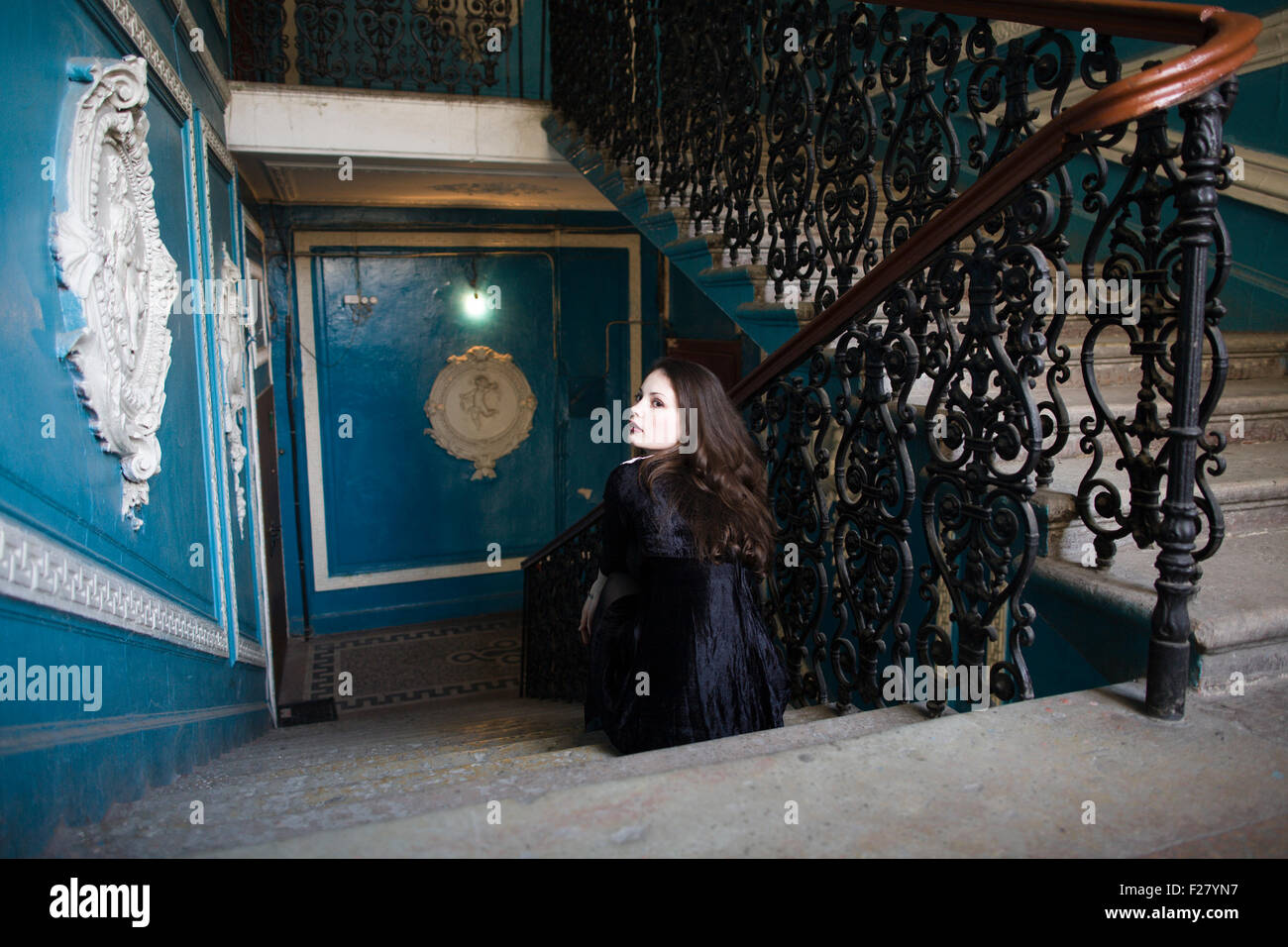 young pretty woman sitting on antique stairs european interior Stock ...