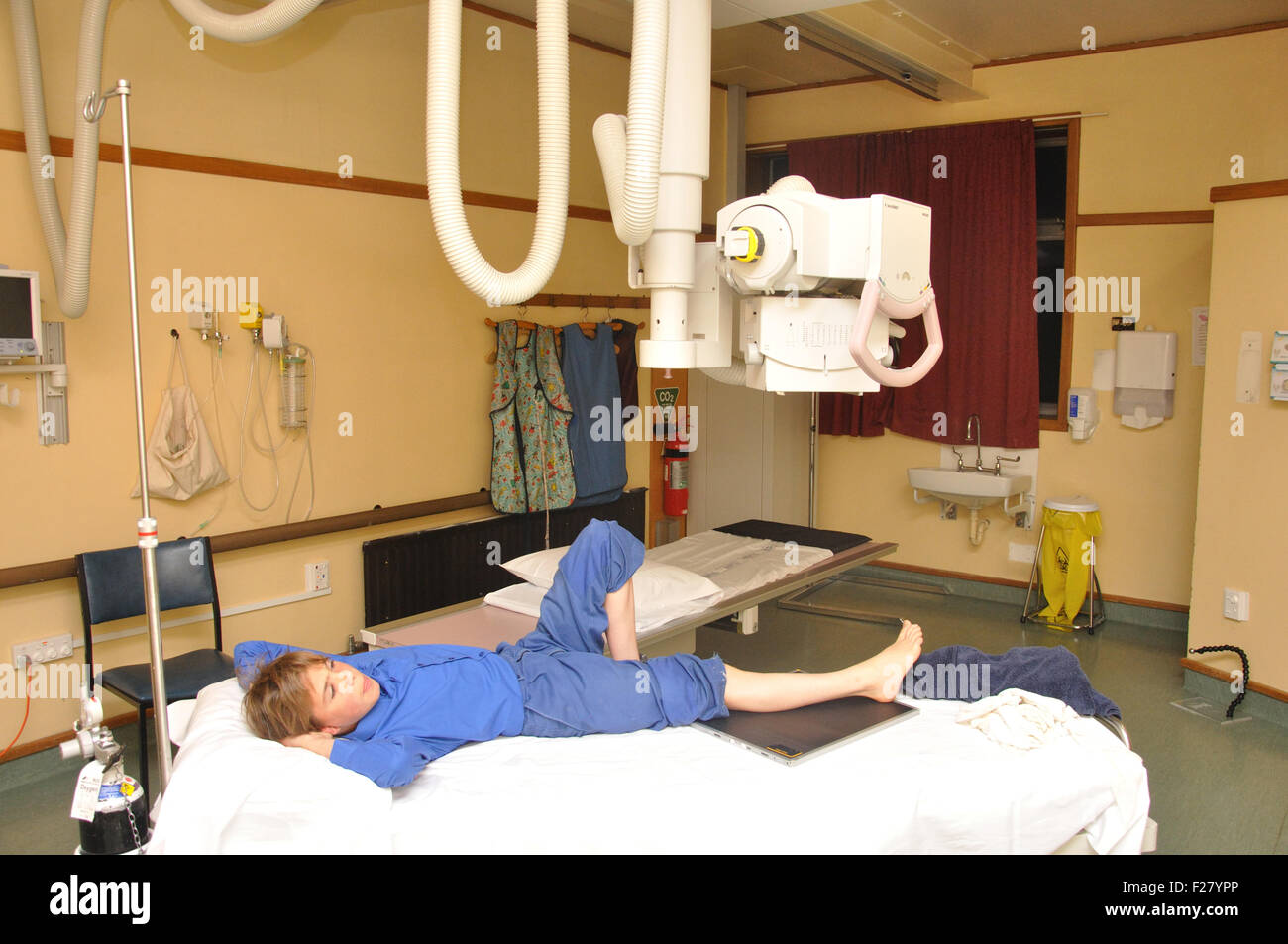 Injured boy waiting for a radiographer to take an X-ray of his broken ...