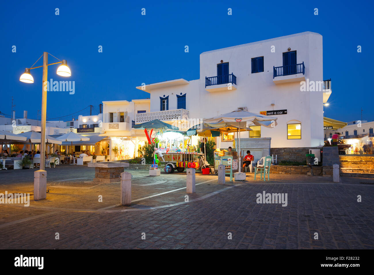 Shops on the seafront in the harbour of Naousa village on Paros island ...