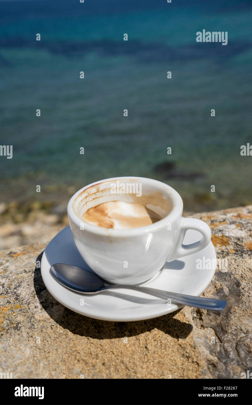 Cup of coffee on ledge at seaside, Puglia, Italy Stock Photo - Alamy