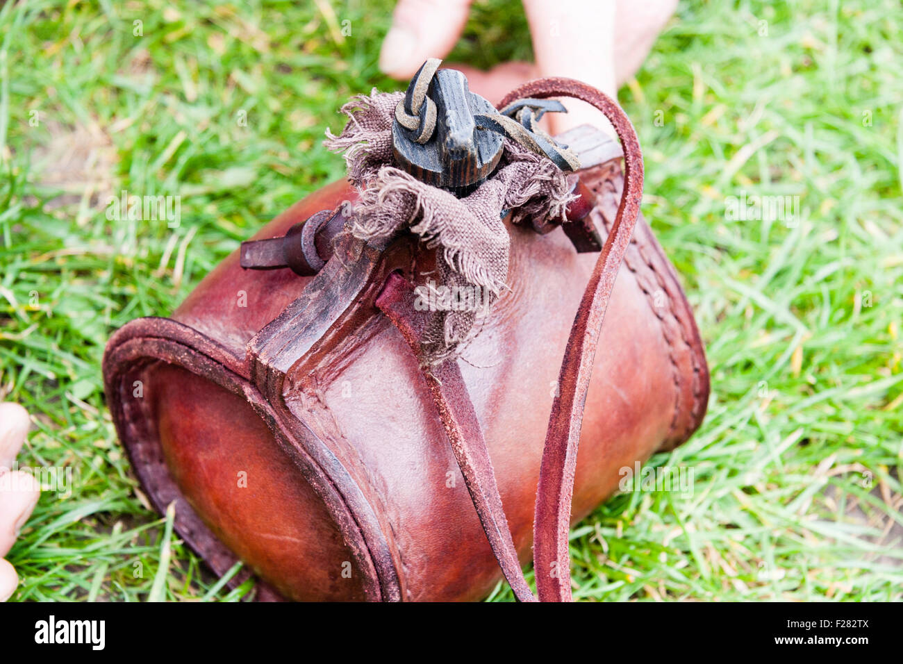 England. Handmade medieval costrel, a leather water or mead bottle ...