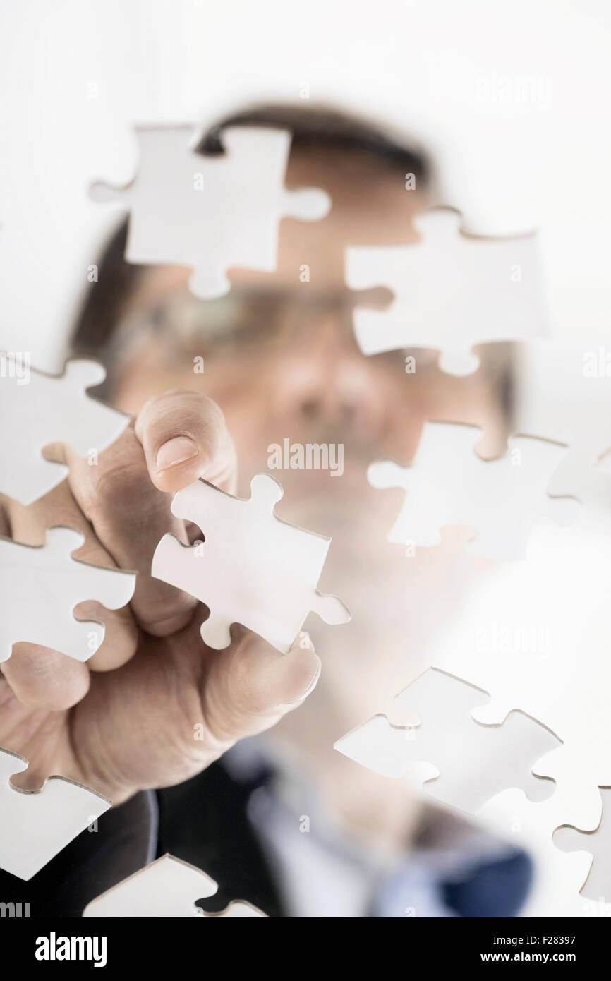 businessman arranging jigsaw puzzle pieces, Bavaria, Germany Stock ... businessman arranging jigsaw puzzle pieces, Bavaria, Germany Stock ...