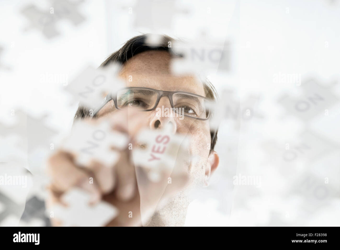 Businessman arranging jigsaw puzzle pieces, Bavaria, Germany Stock ...