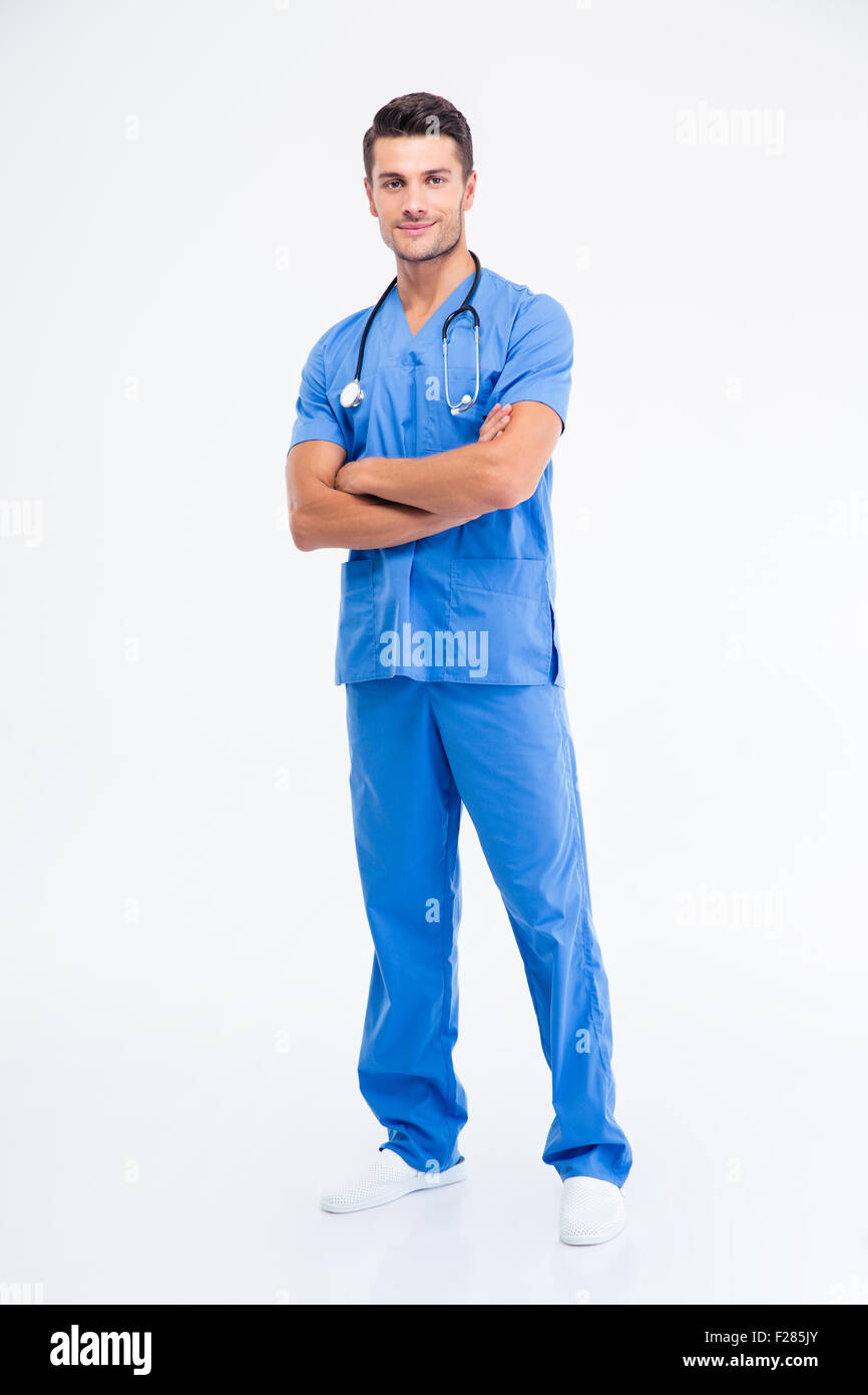 Full length portrait of a happy male doctor standing with arms folded ...