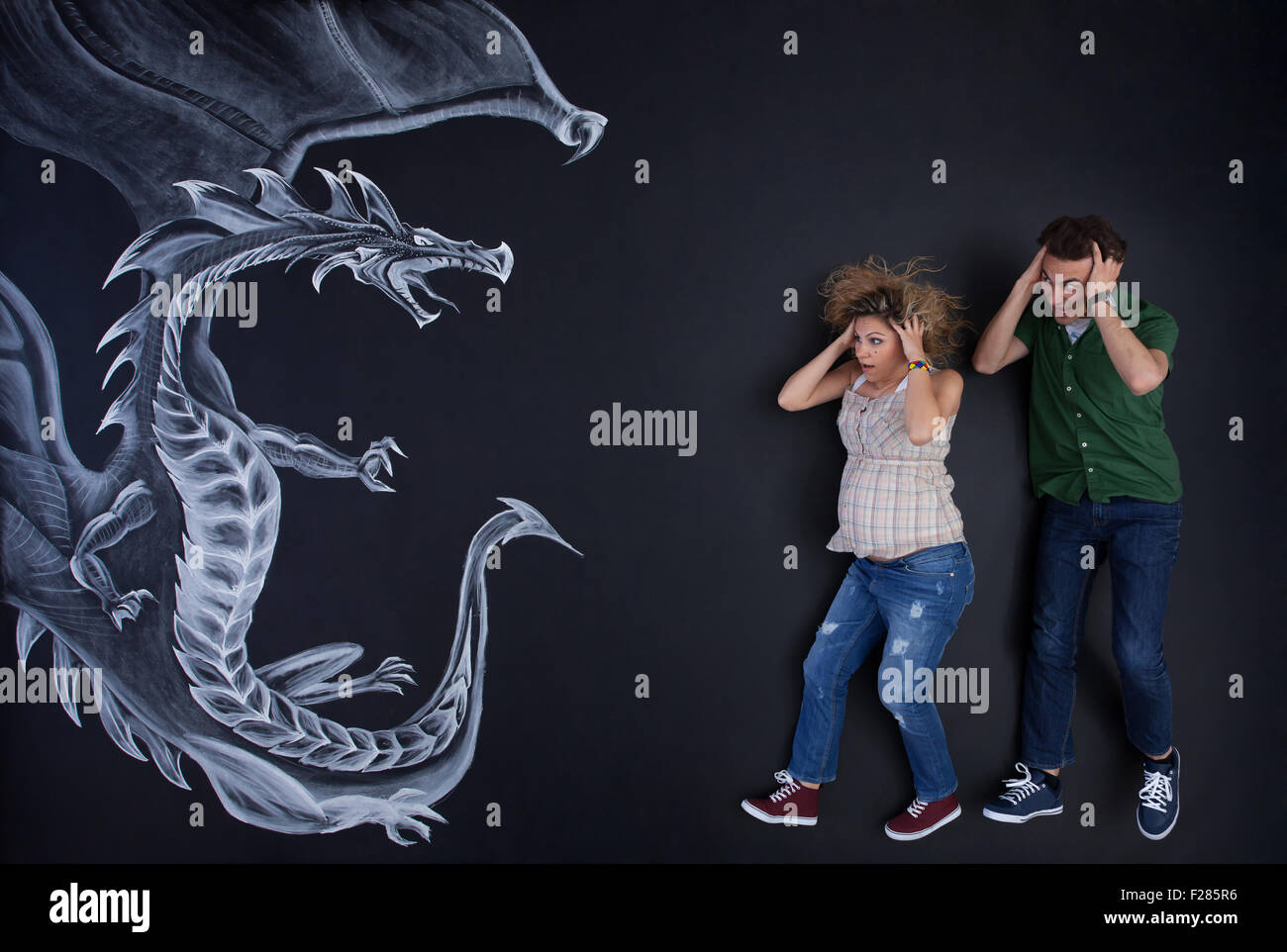 Young couple being scared about a big dragon Stock Photo - Alamy