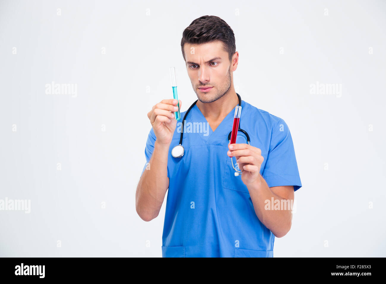 Portrait of a male doctor with test tube isolated on a white background ...