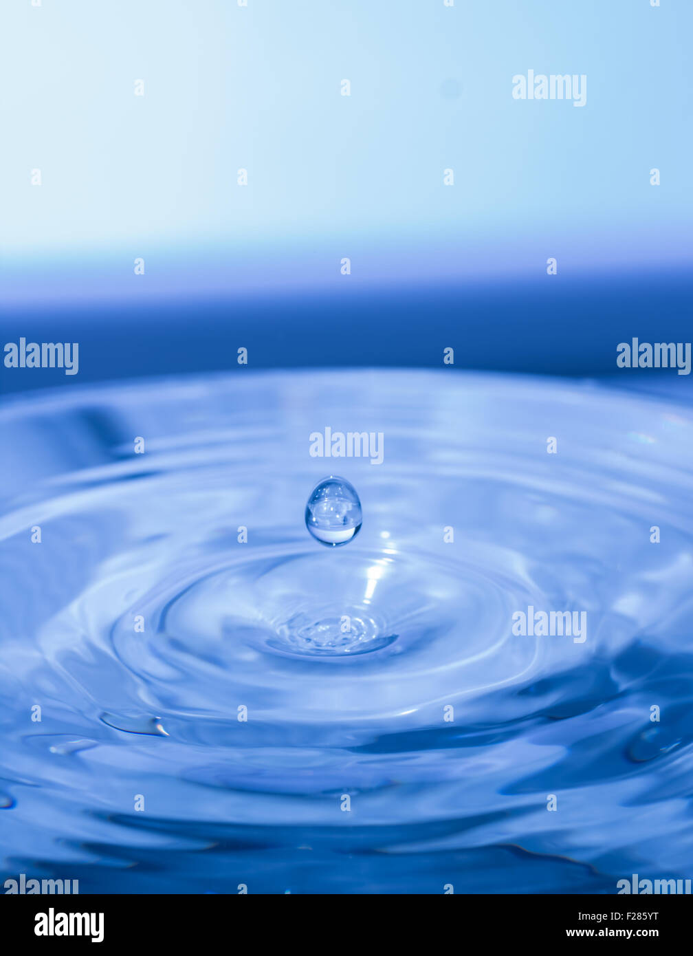 Drop of water falling on water level Stock Photo - Alamy