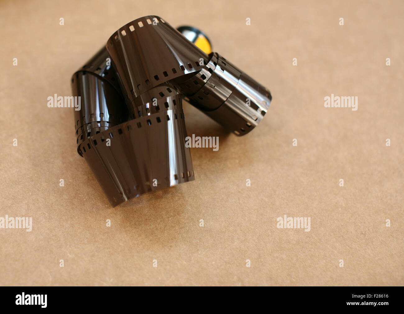 Curling 35mm film on beige background Stock Photo - Alamy
