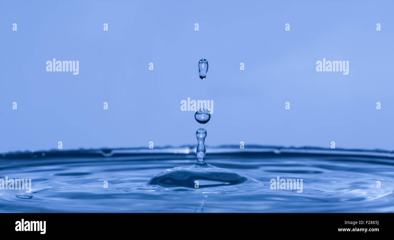 Drop of water falling on water level Stock Photo - Alamy