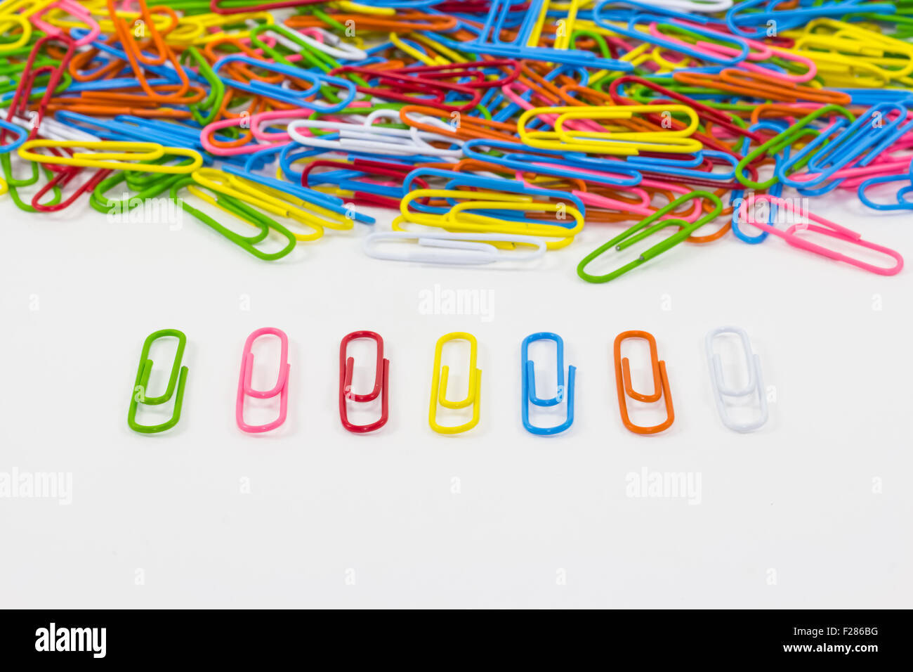 Colorful paperclips on white background focus on front seven clips ...