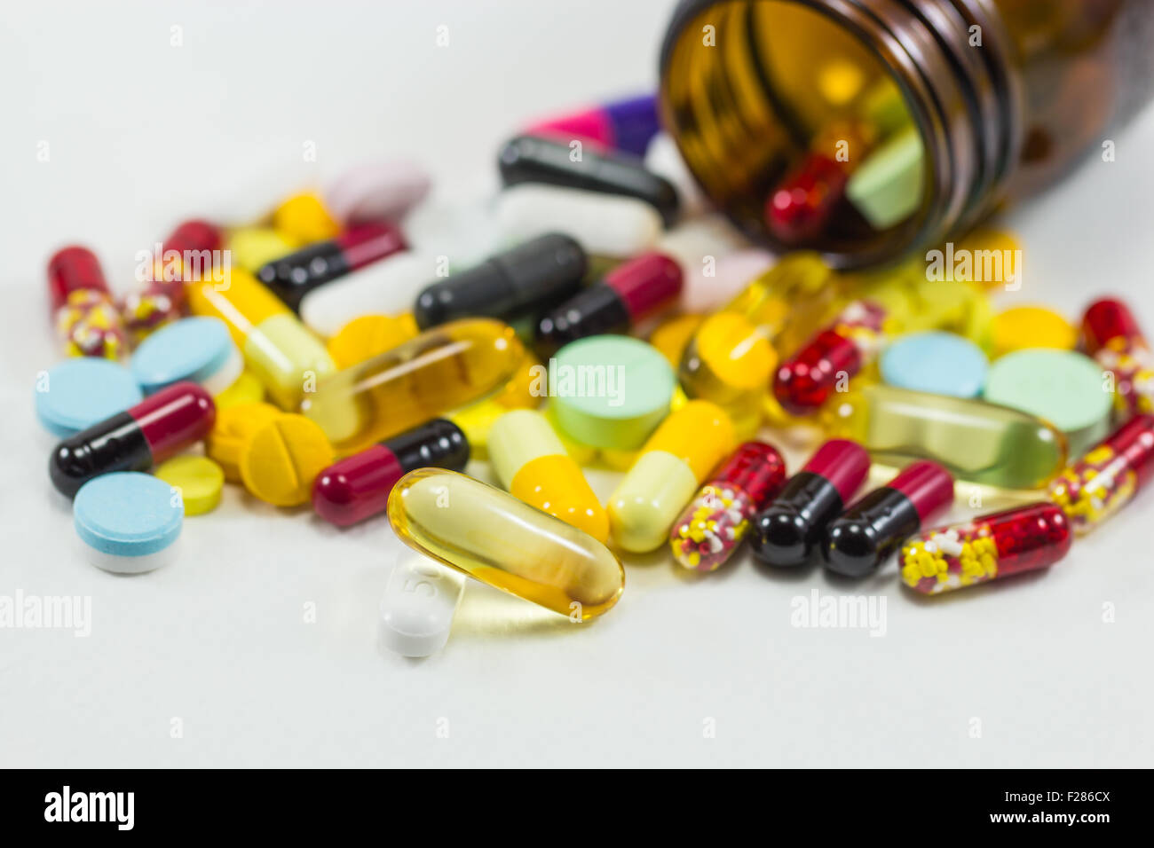 diferent Tablets pills capsule heap mix isolated on white background ...