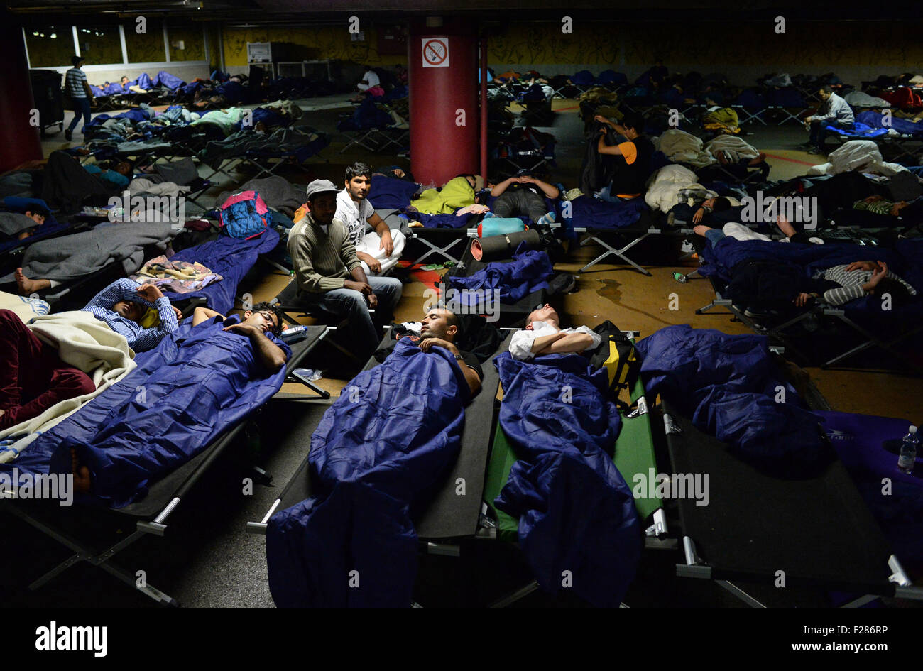 Salzburg, Germany. 13th Sep, 2015. Refugees sleep on camp beds in an ...