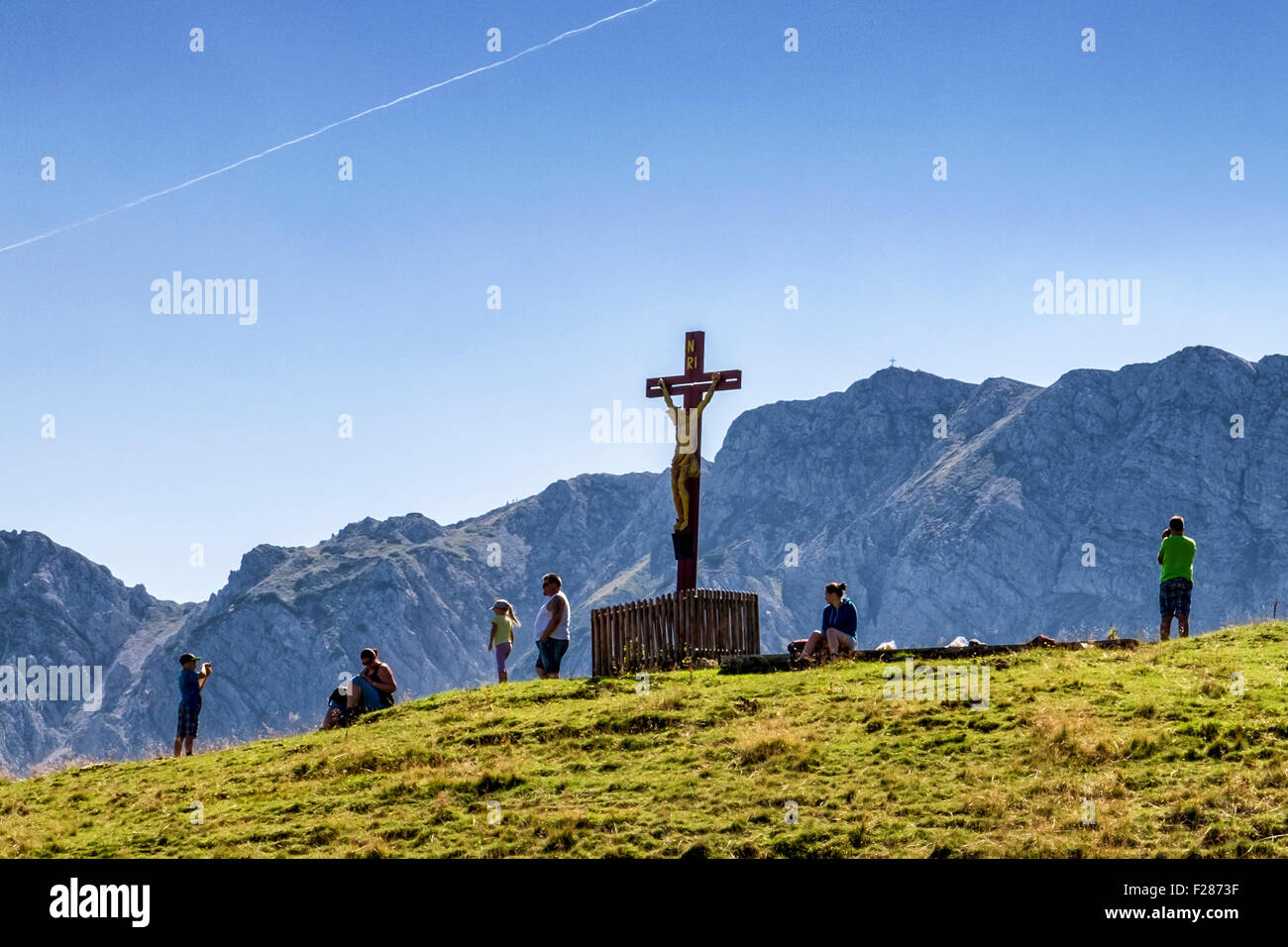 Crucifix, Cross and tourists hiking in the Bavarian Alps, Breitenberg ...