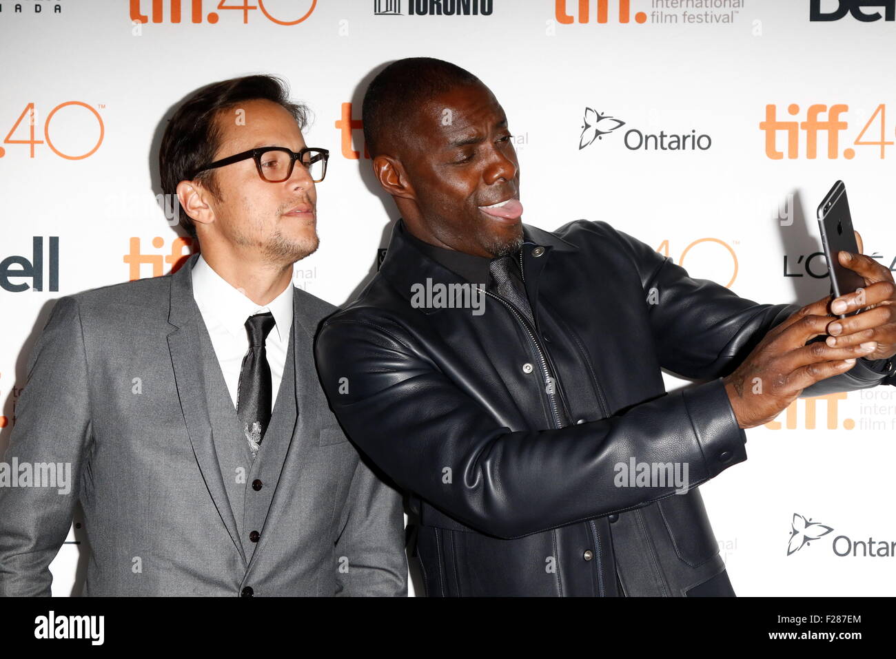 Director Cary Fukunaga and actor Idris Elba (R) attend the premiere of ...