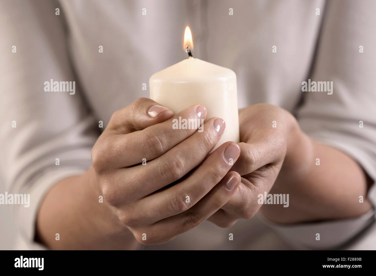 Burning Candle In Hands