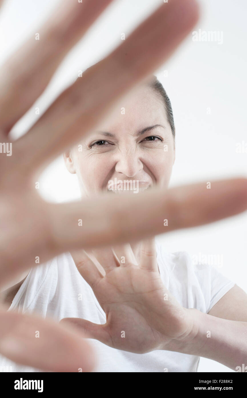 Mature woman showing stop sign and screaming, Bavaria, Germany Stock ...