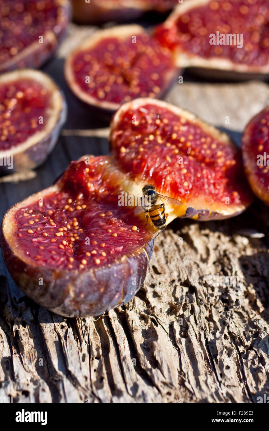Open figs on wooden surface Stock Photo - Alamy