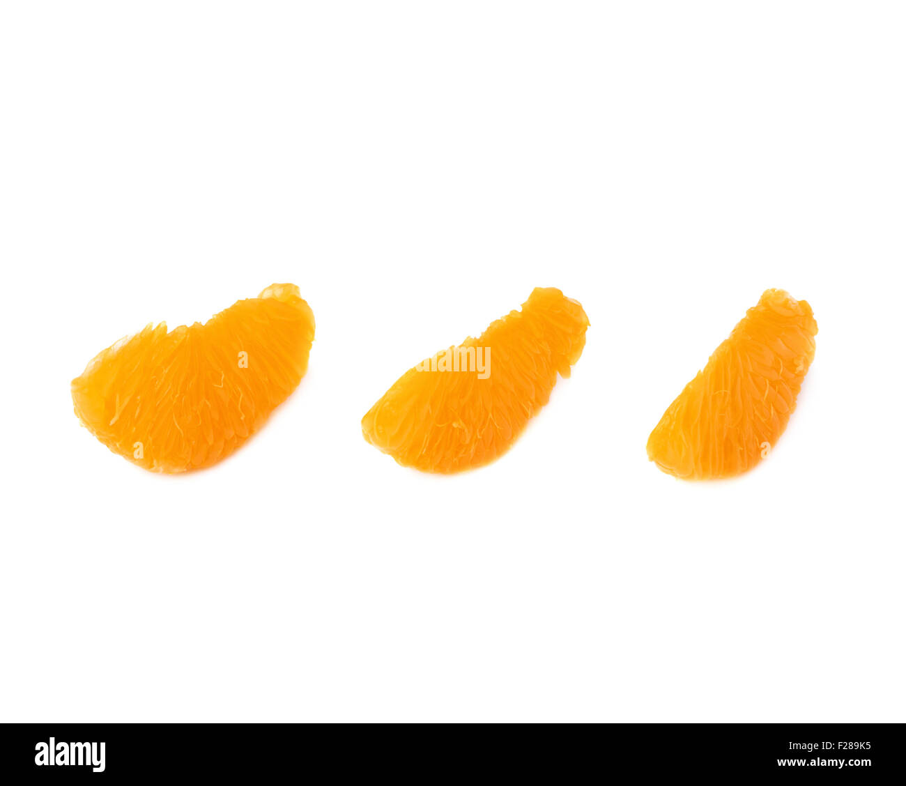 Slice sections of ripe tangerine isolated over the white background ...