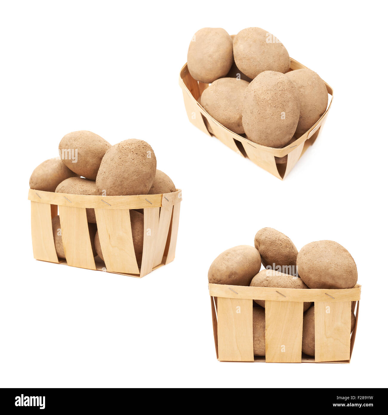 Pile of earth dirty potatoes in a wooden basket, composition isolated ...