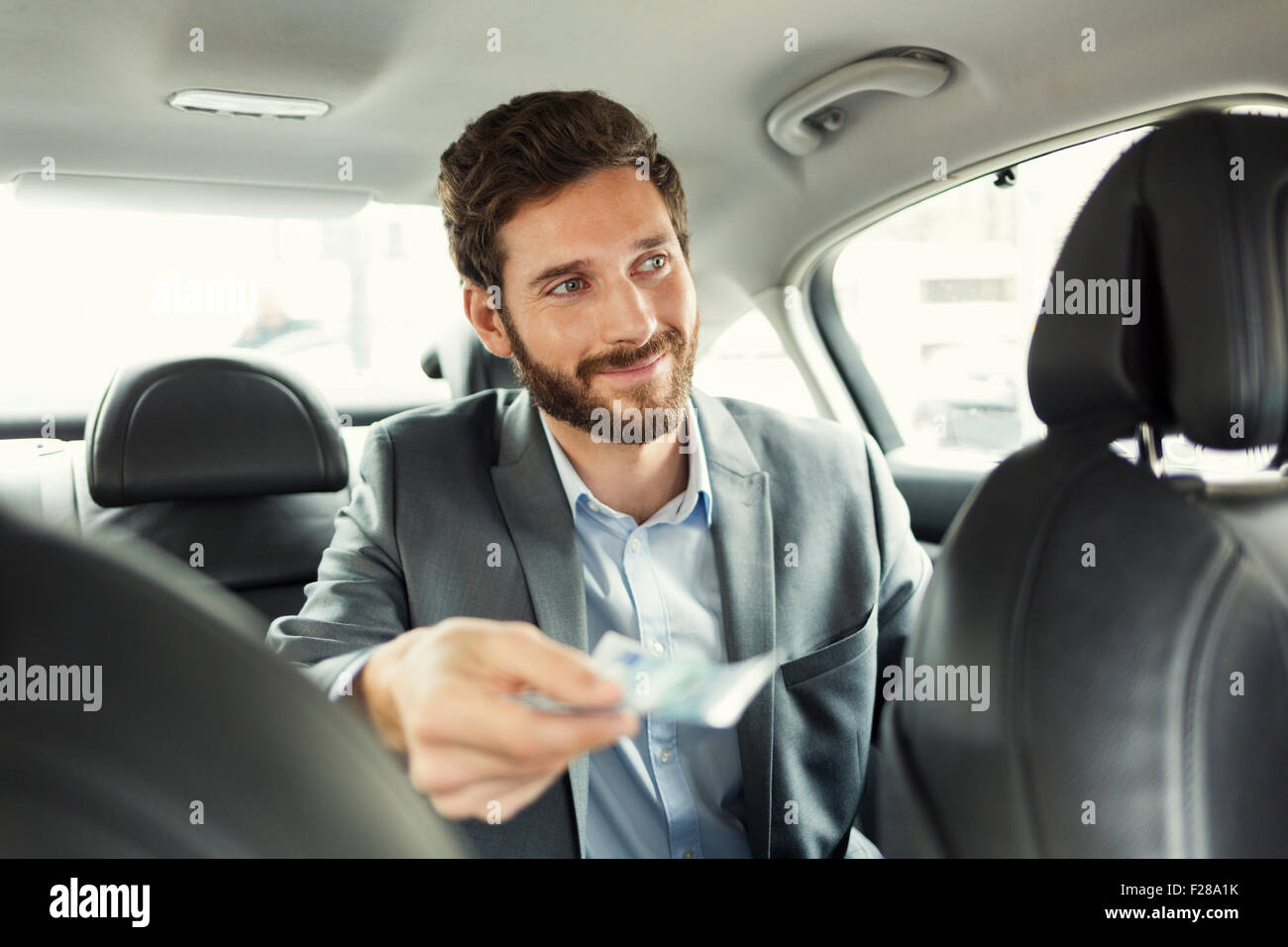 Man paying the taxi with the cash Stock Photo - Alamy