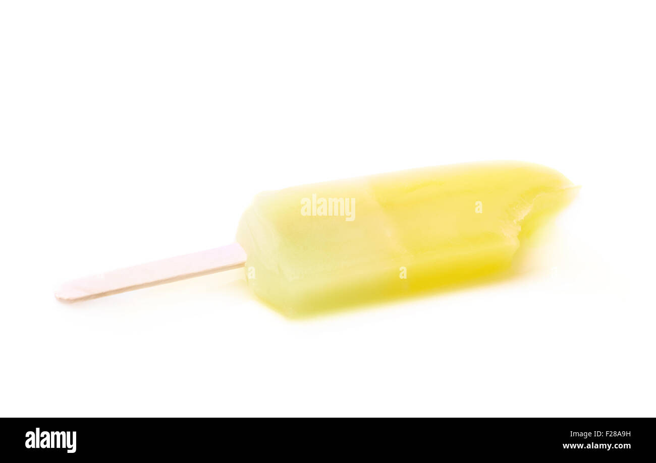 Frozen fruit juice ice pop yellow and green popsicle snack on a wooden ...