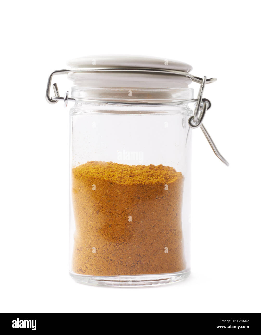 Glass jar filled with the yellow curry powder isolated over the white ...