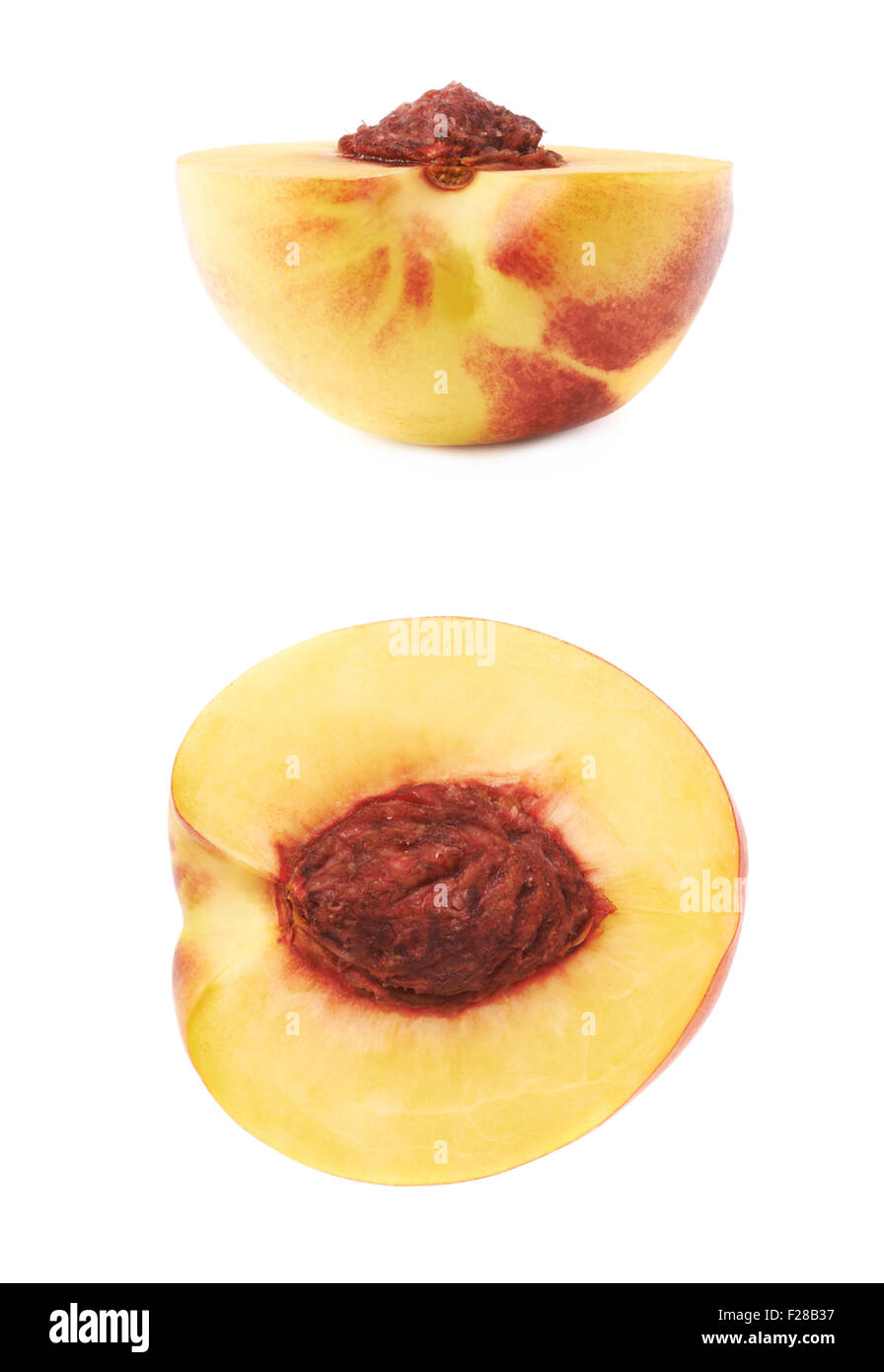 Cut open ripe nectarine half with a pit, composition isolated over the ...