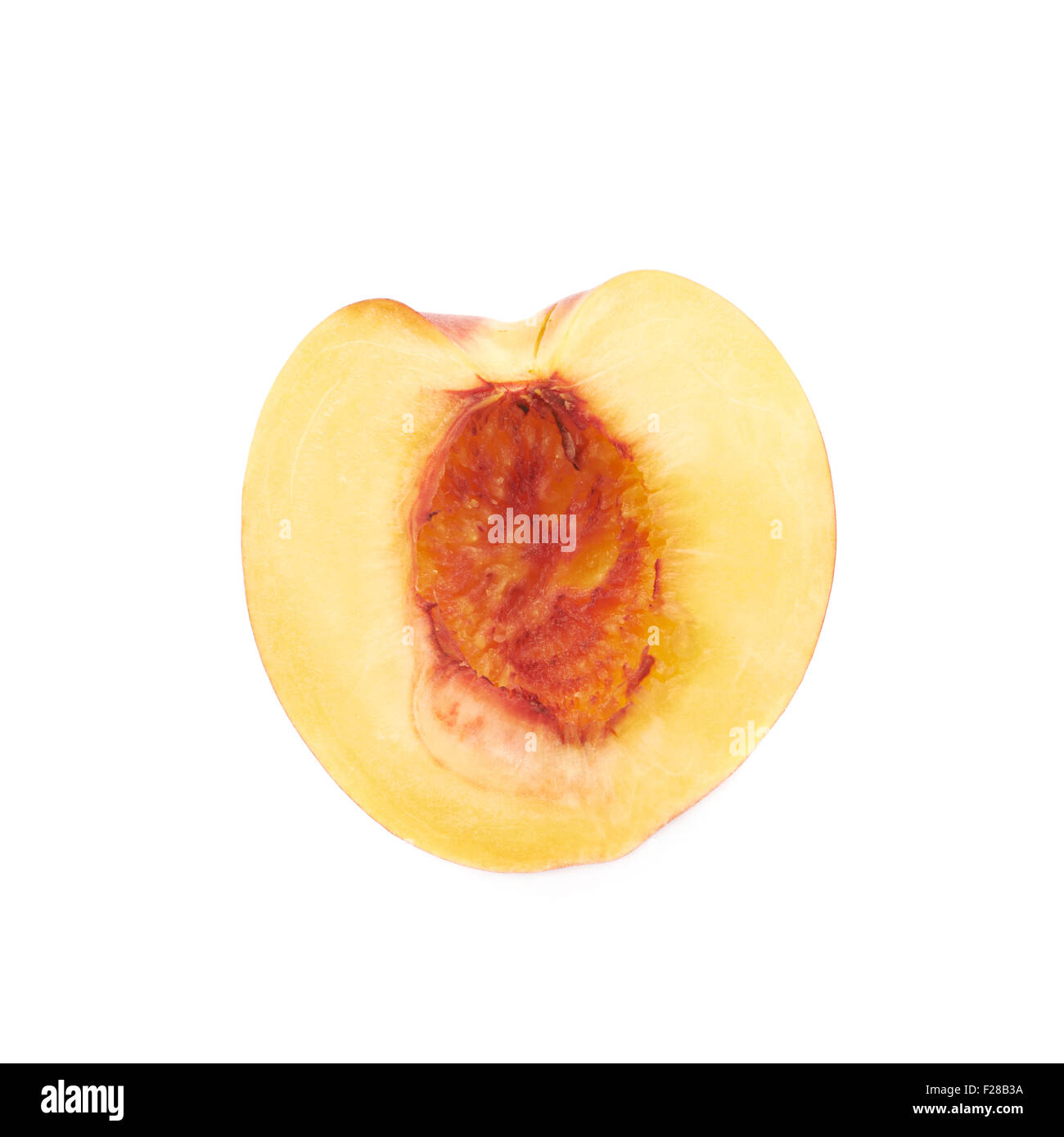 Cut open ripe nectarine half without pit, isolated over the white ...