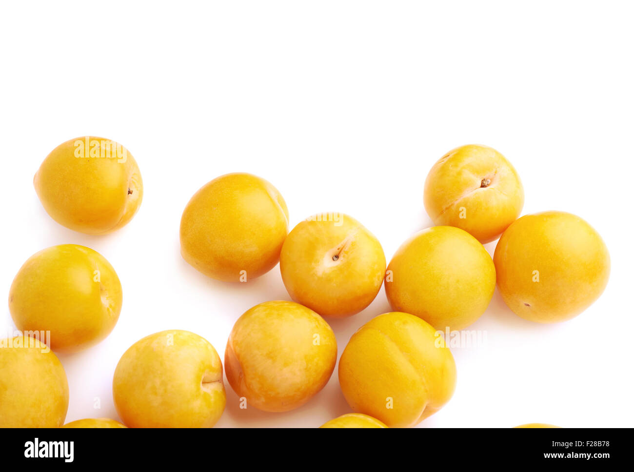 Pile of multiple yellow mirabelle plums isolated over the white ...