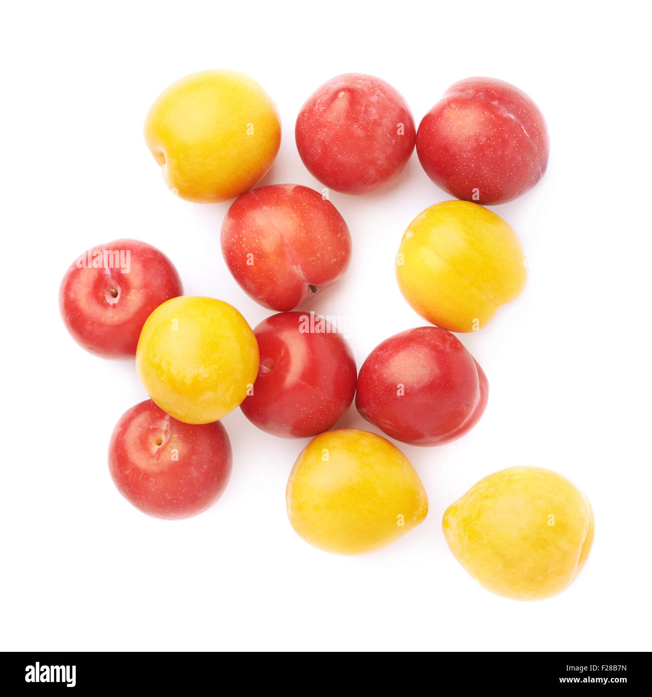 Pile of multiple yellow and red plums, composition isolated over the ...