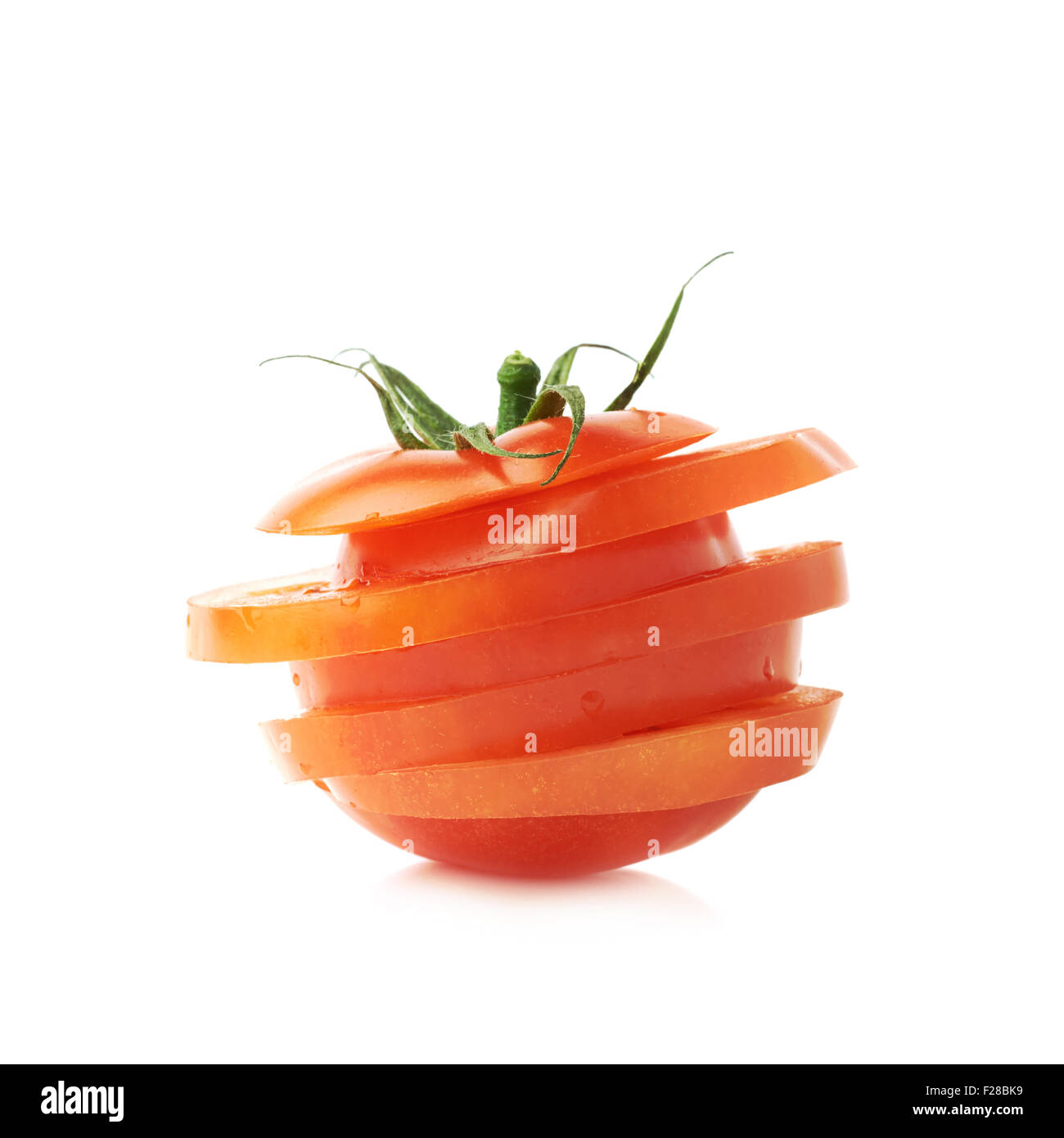 Tomato cut in slices isolated Stock Photo - Alamy