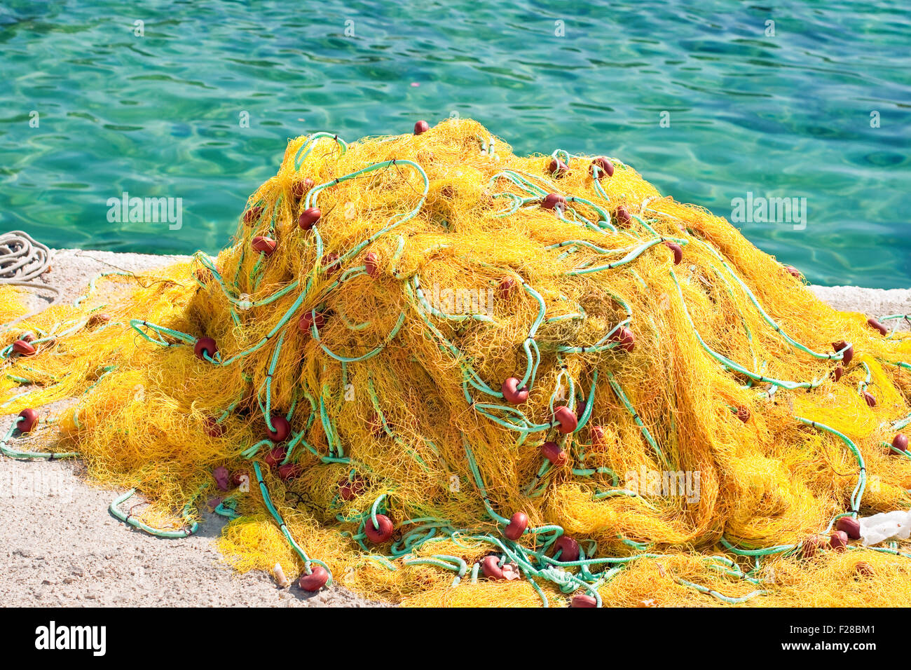 Yellow fishing nets next to the sea Stock Photo - Alamy