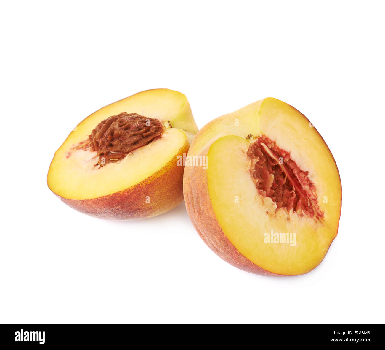 Two halves of a peach fruit isolated Stock Photo - Alamy