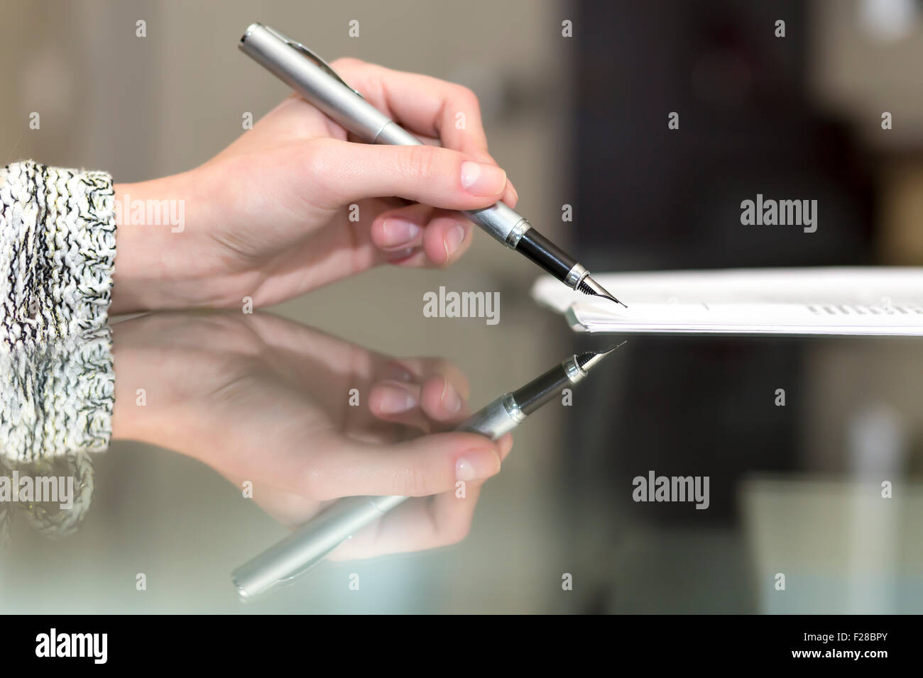 Lady signs formal document Stock Photo - Alamy