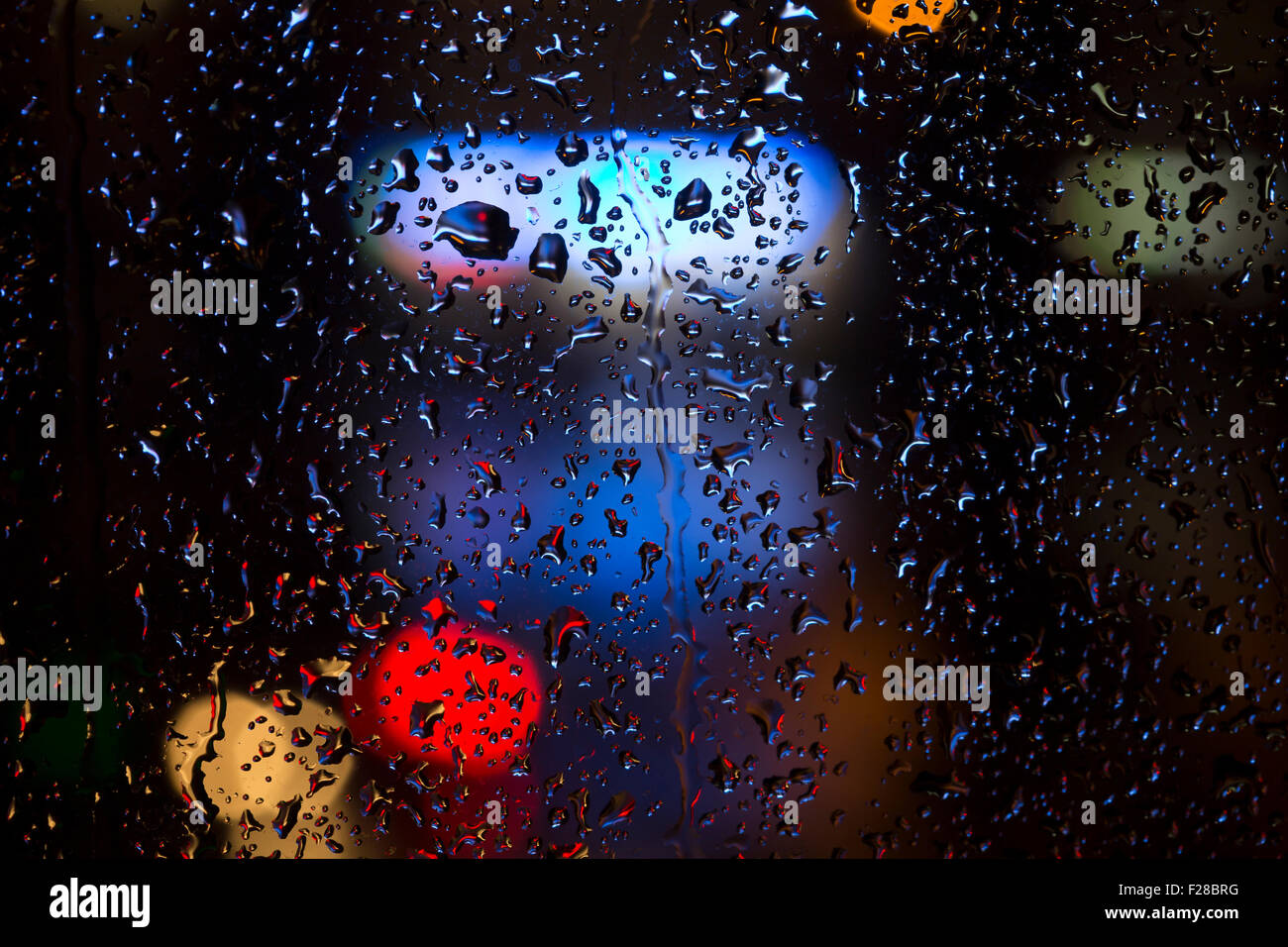 Raindrops on the window with evening city lights Stock Photo - Alamy