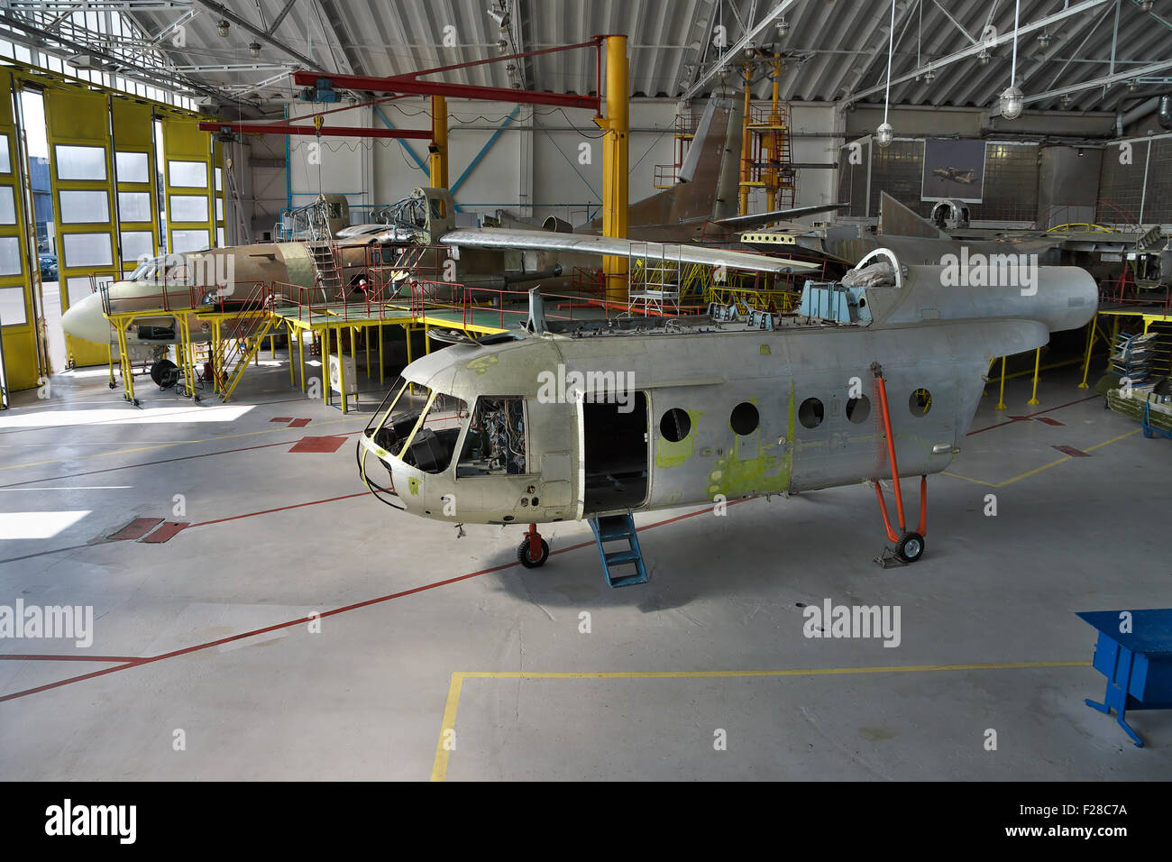 Helicopter and plane in the assembly shop at the maintenance facility ...