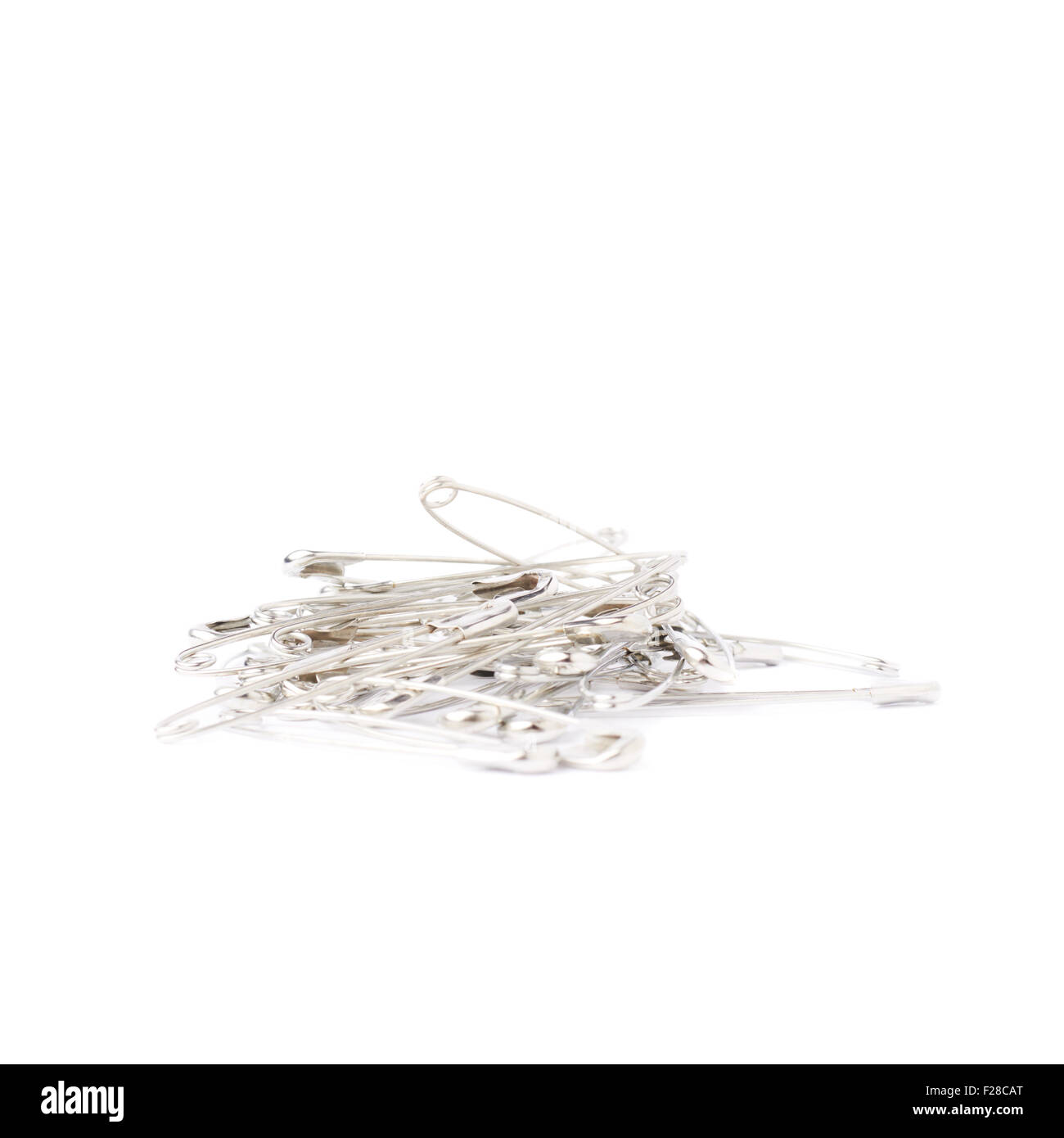 Pile of safety pins isolated on white background Stock Photo - Alamy
