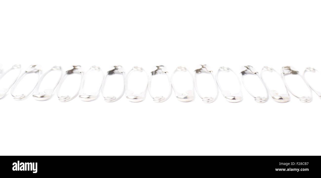 Line border made of multiple safety pins isolated on white background ...