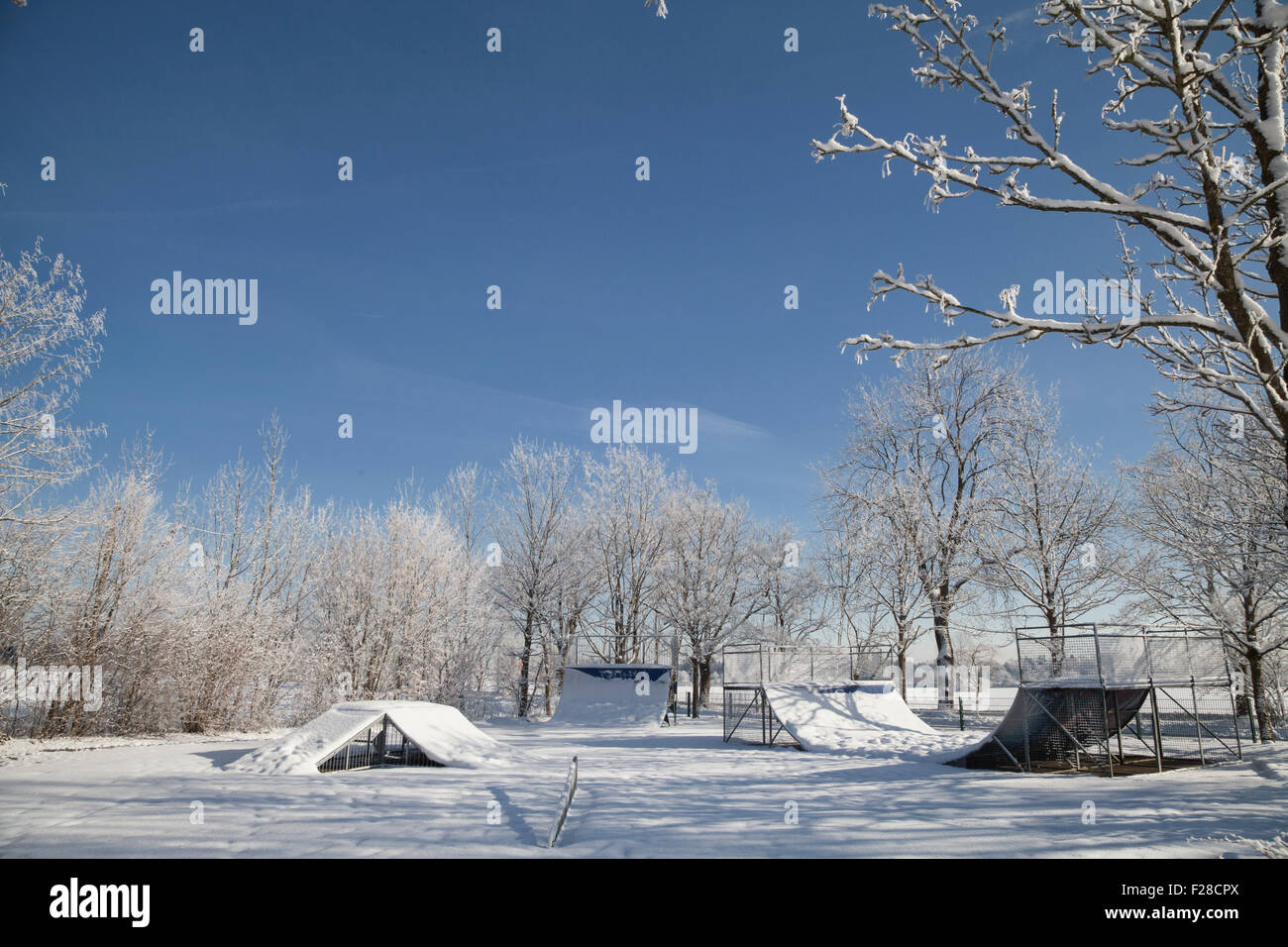 Snow covered sports ramp in playground, Eichenau, Fürstenfeldbruck ...