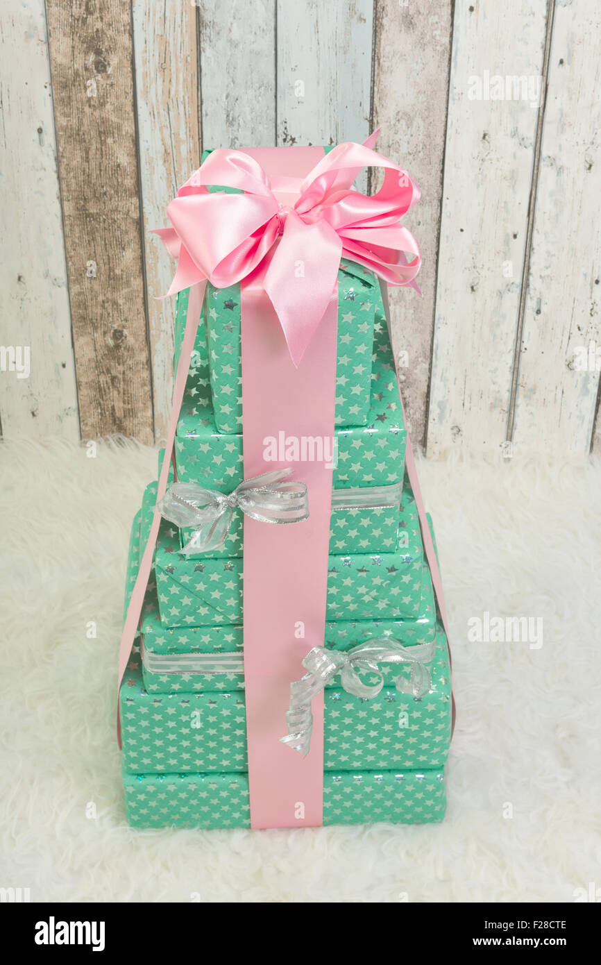 Stack of six christmas presents wrapped in a pink bow Stock Photo - Alamy
